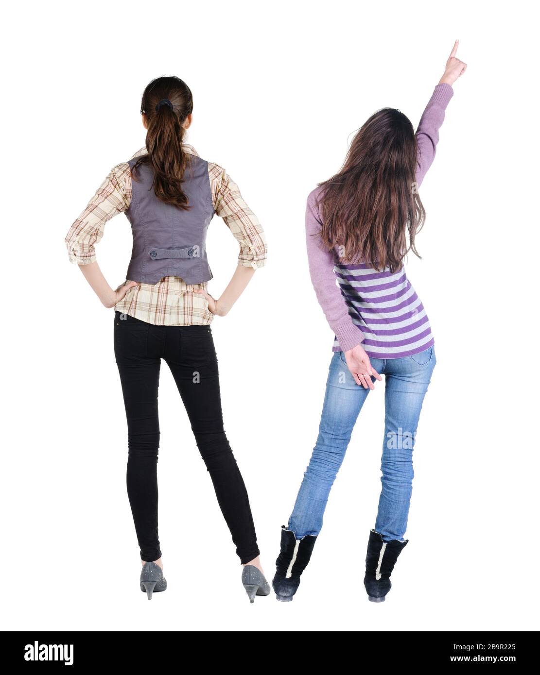Back view of two pointing girl in sweater. Rear view people collection ...