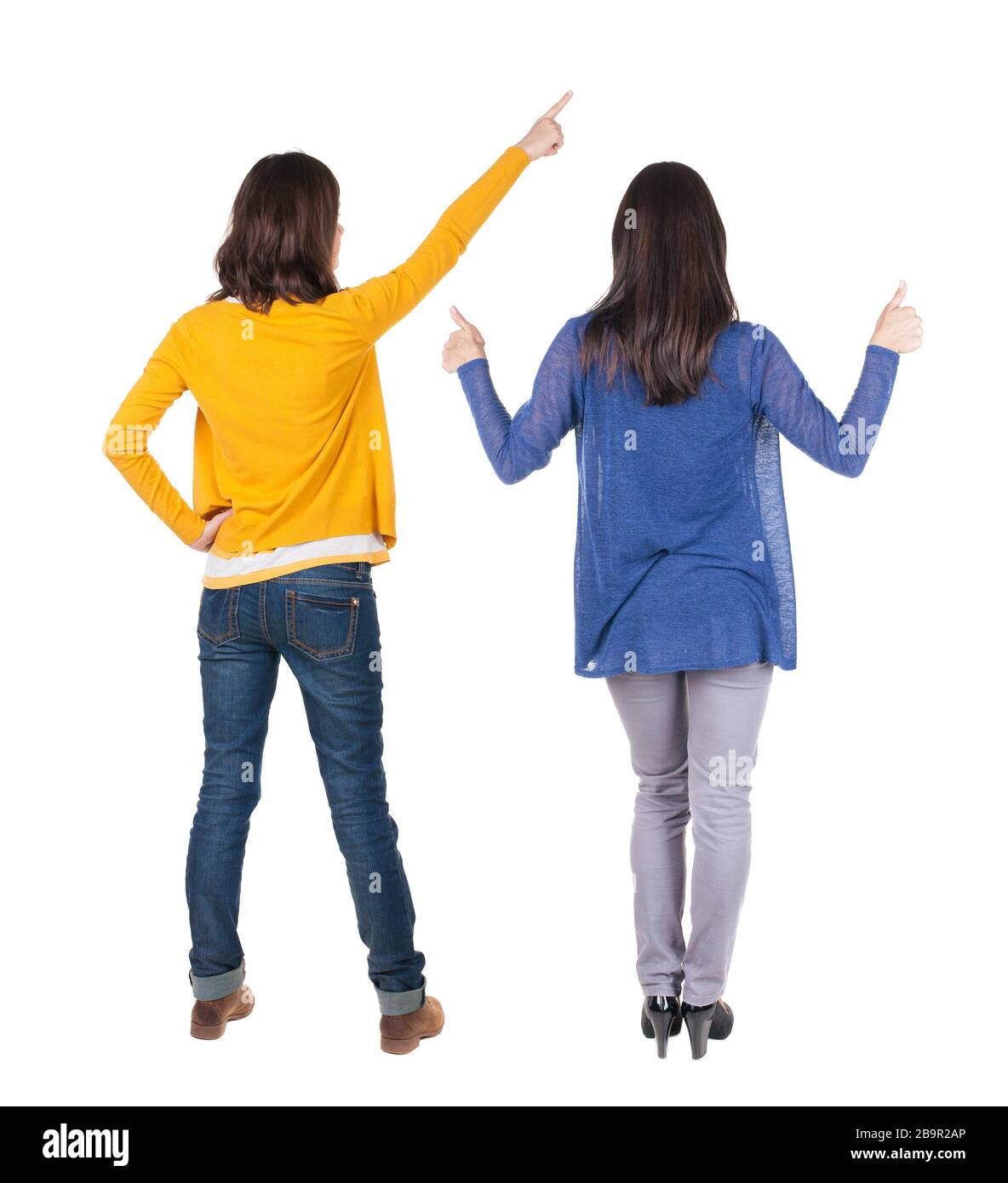 Back view of two pointing girl in sweater. Rear view people collection ...