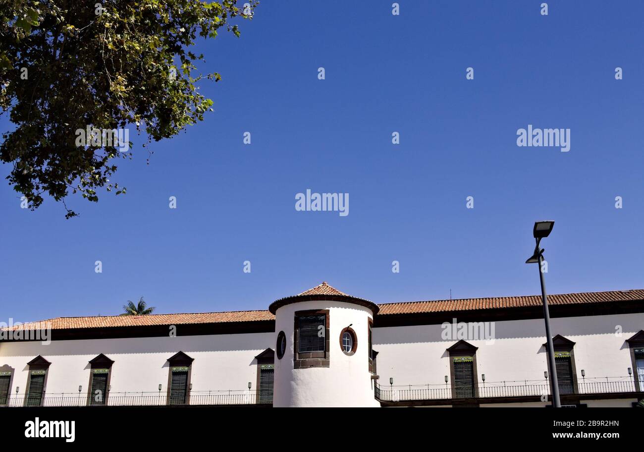 Facade of a white traditional building with a rounded tower (Madeira ...