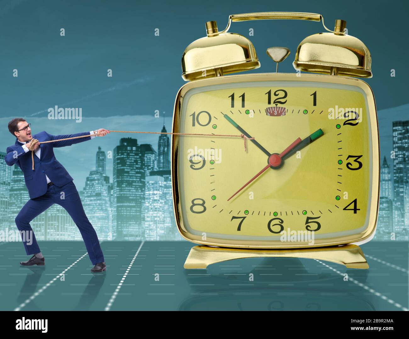 The businessman pulling clock in time management concept Stock Photo ...