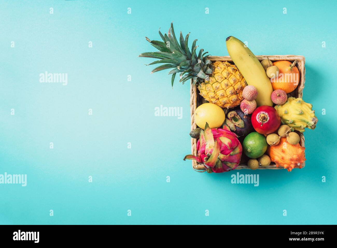 Tropical fruits on blue background. Rattan box full of exotic thailand ...