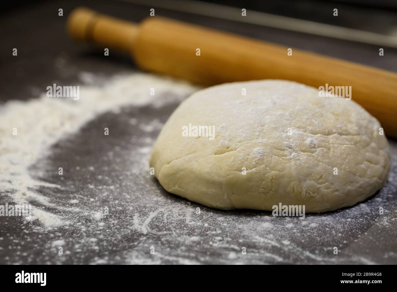 flour dough for baking cookies on the kitchen table Stock Photo - Alamy