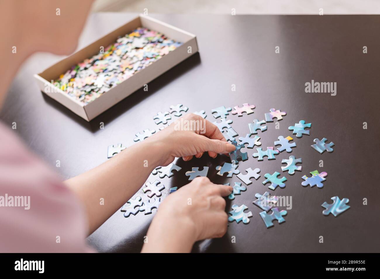 Self-isolated senior lady playing jigsaw puzzles at home Stock Photo ...