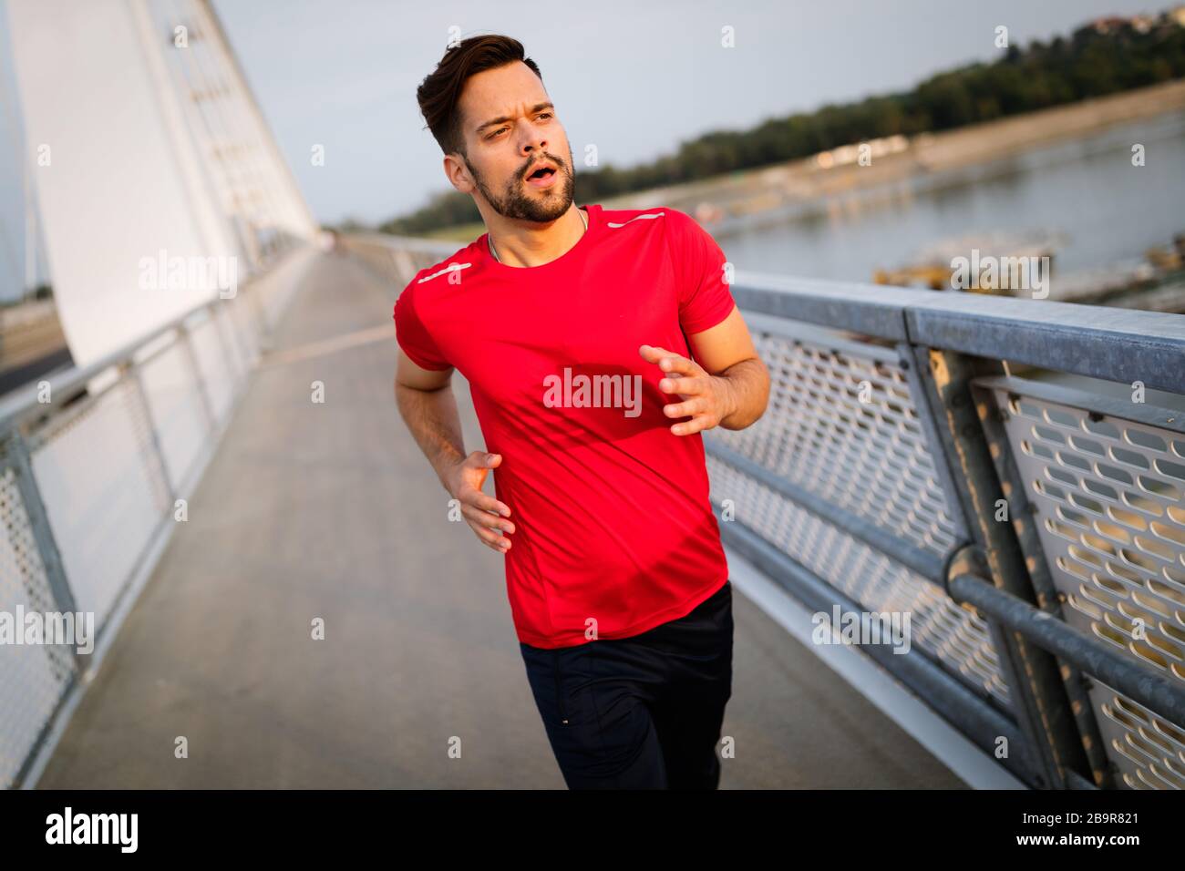 Female athlete running across bridge hi-res stock photography and ...