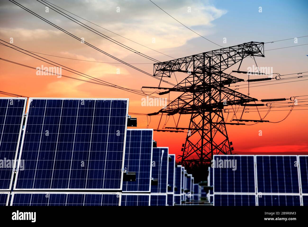Pylon and photovoltaic panels in the evening Stock Photo - Alamy