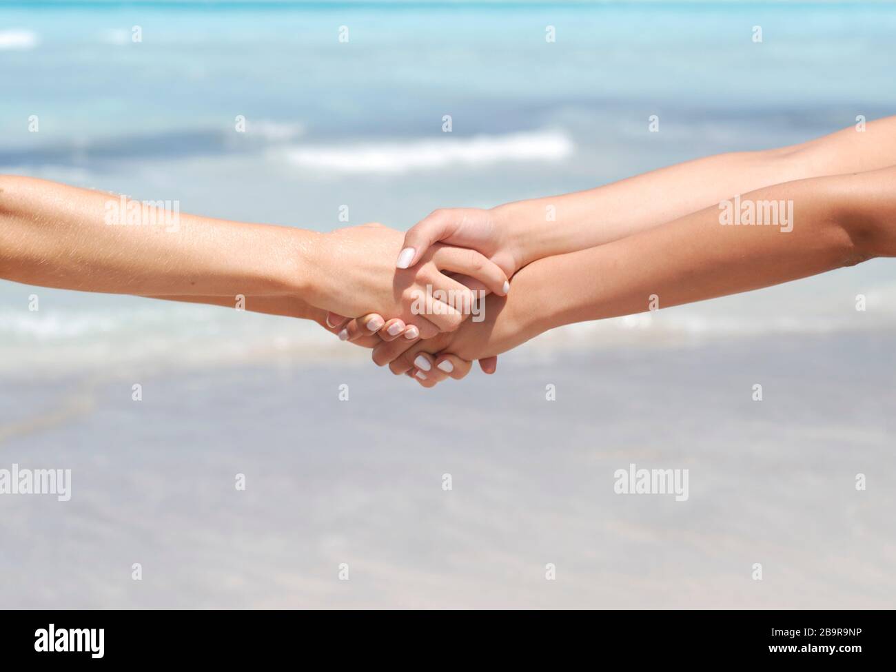 young women on the beach, hands Stock Photo - Alamy