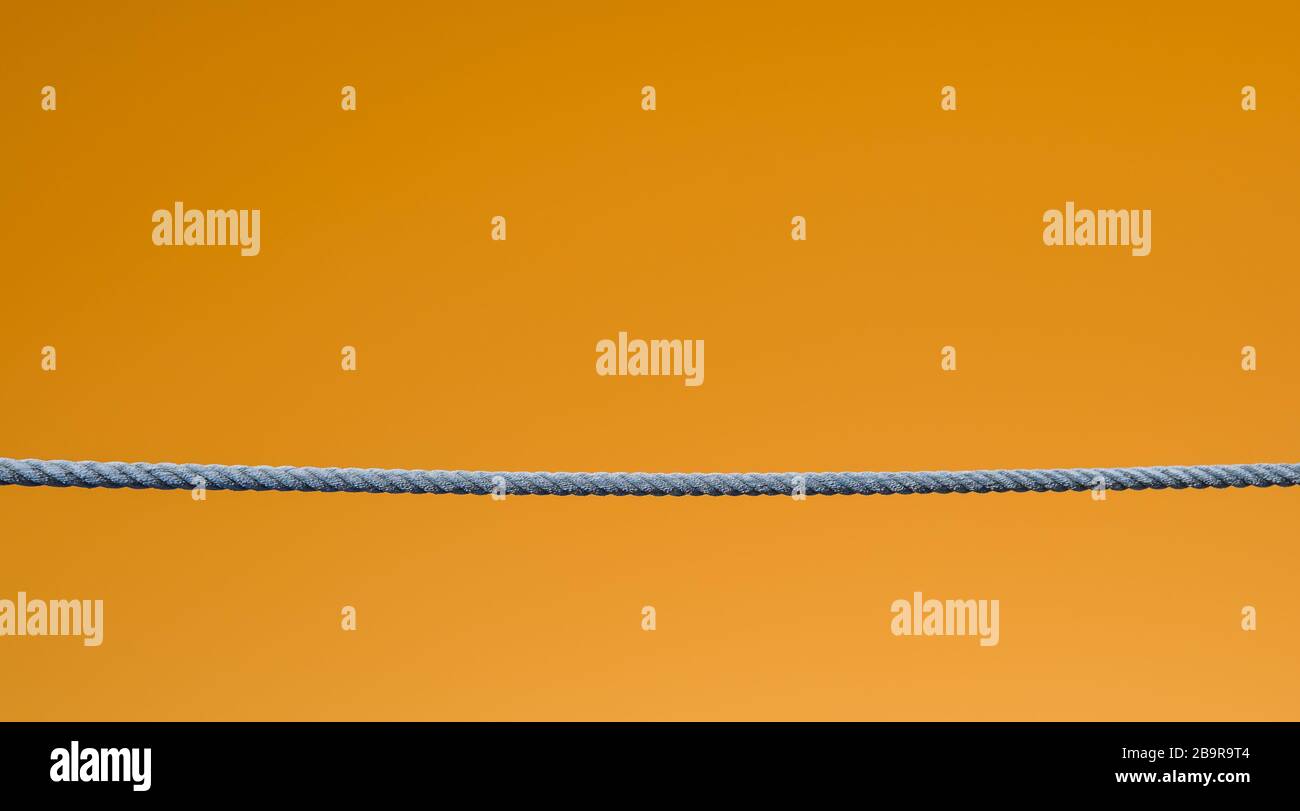 a empty rope stretched on a orange background Stock Photo - Alamy