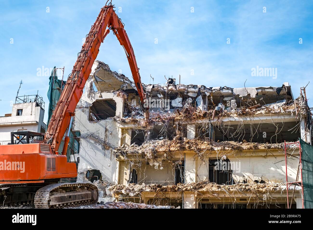 Building demolition with hydraulic excavator Stock Photo - Alamy