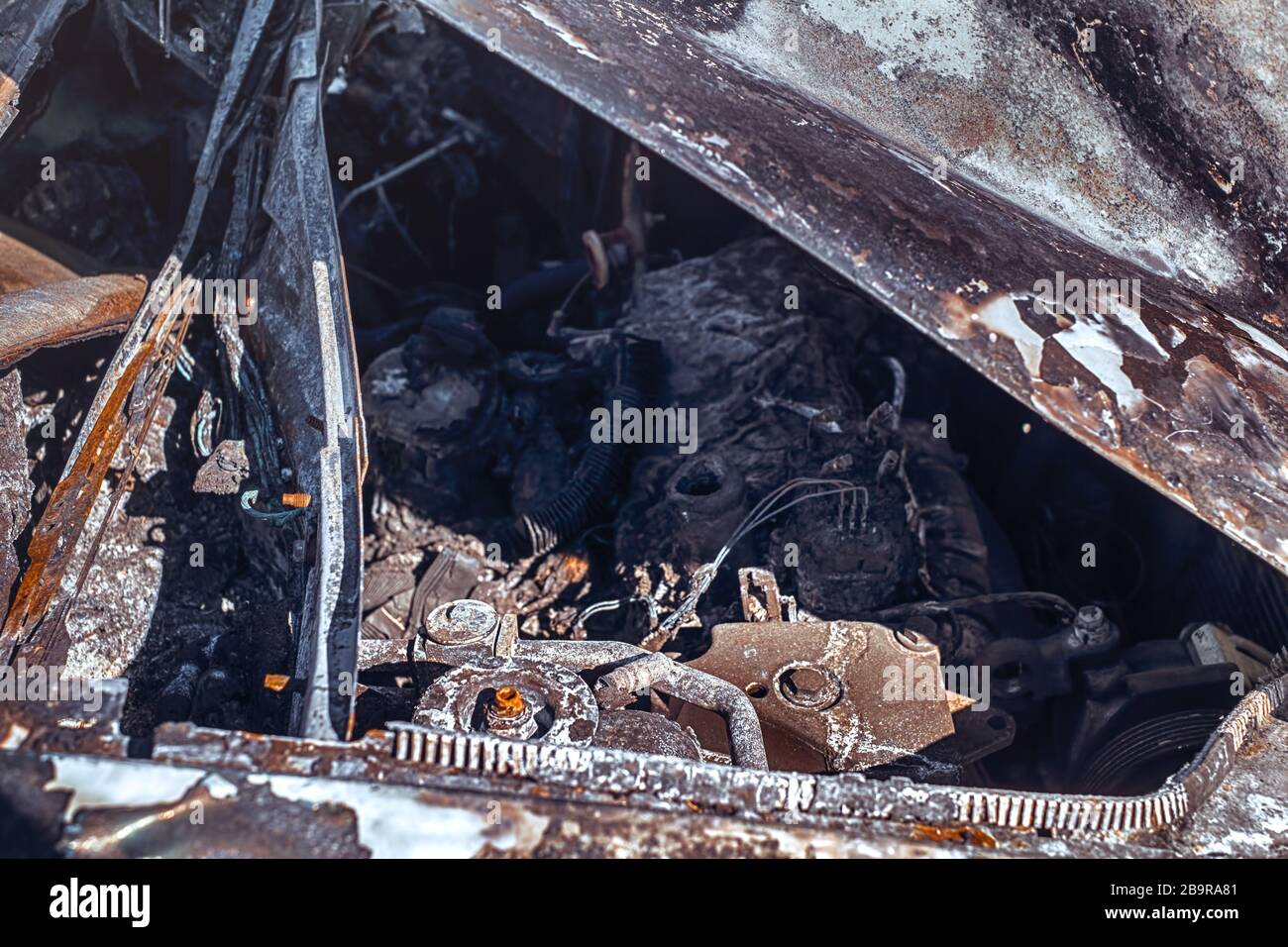 Burnt out car engine with hood Stock Photo - Alamy
