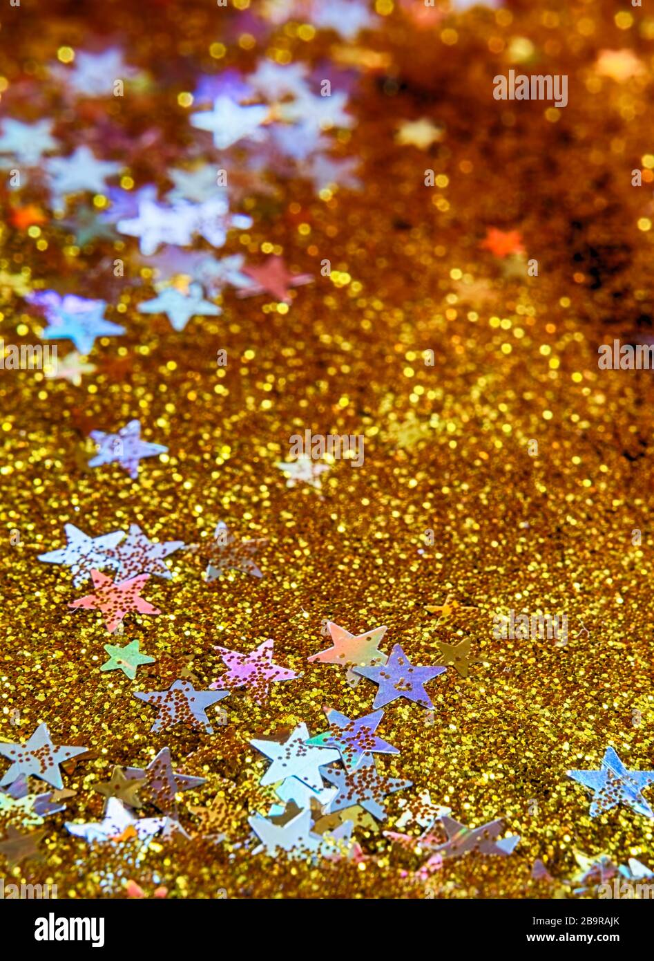 golden sparkles and multicolour stars background Stock Photo - Alamy