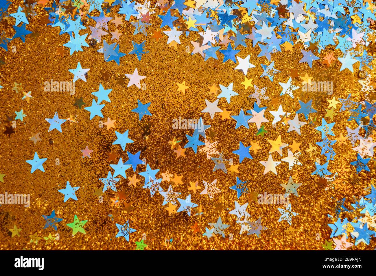 golden sparkles and multicolour stars background Stock Photo - Alamy