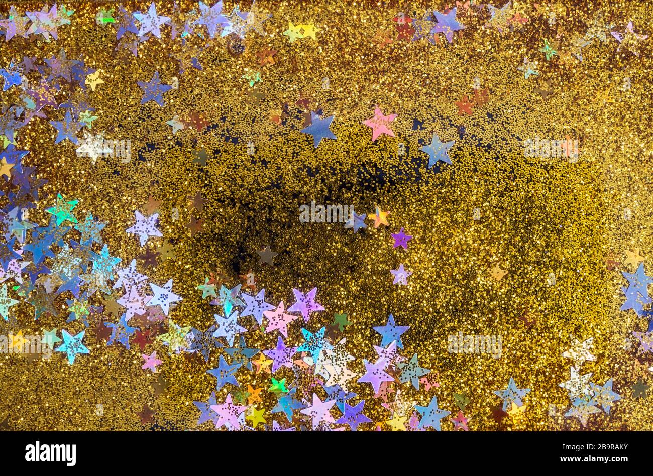golden sparkles and multicolour stars background Stock Photo - Alamy