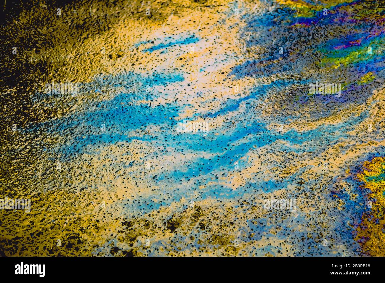 Oil stain on Asphalt road after rain, color Gasoline fuel spots on ...