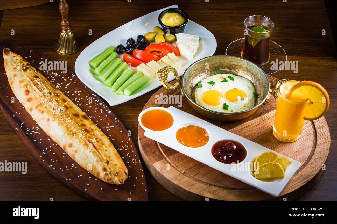 Traditional Turkish Breakfast with sesame bagel and fry egg with ...