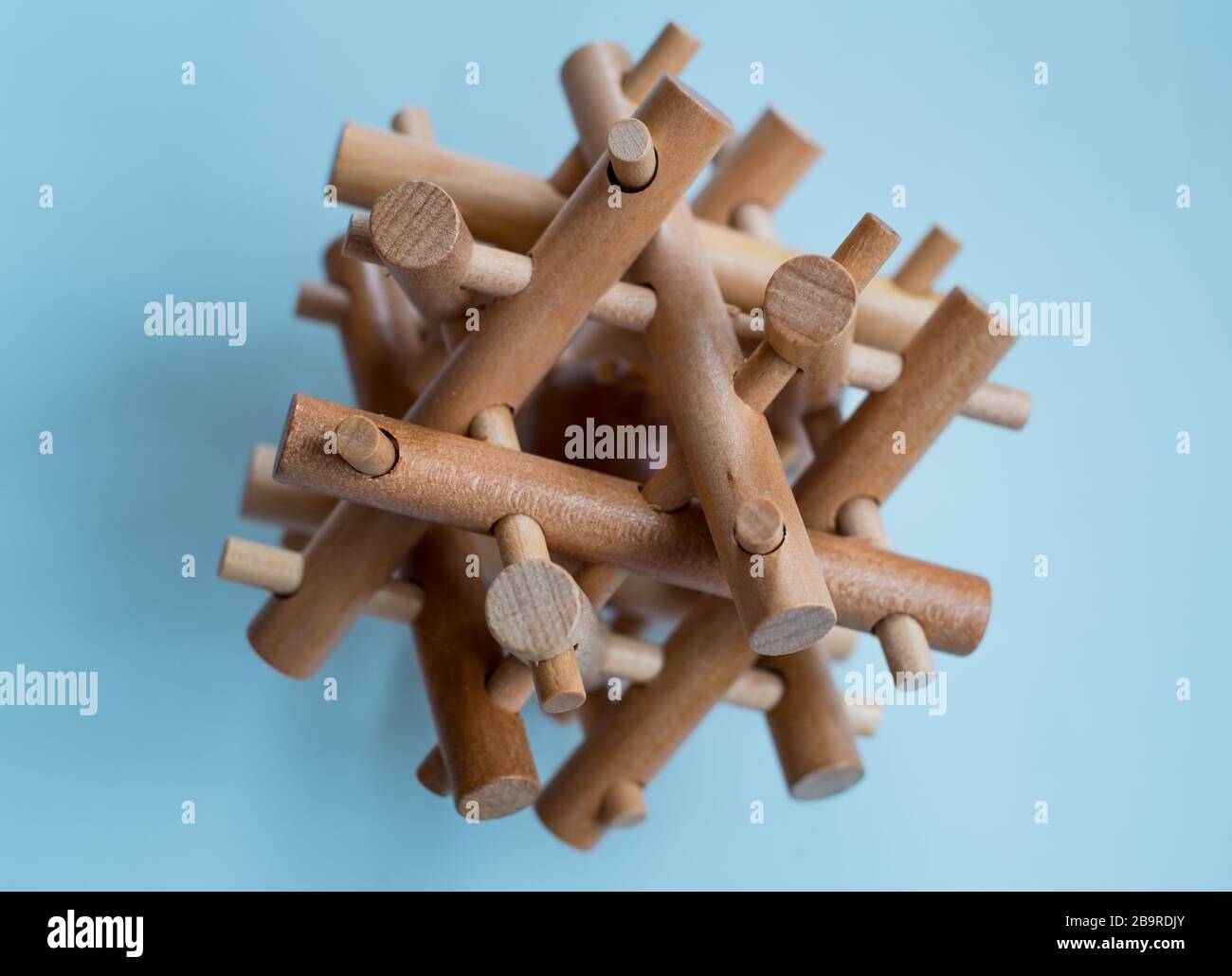 Wooden Brain Bamboo Puzzle on blue background Stock Photo - Alamy