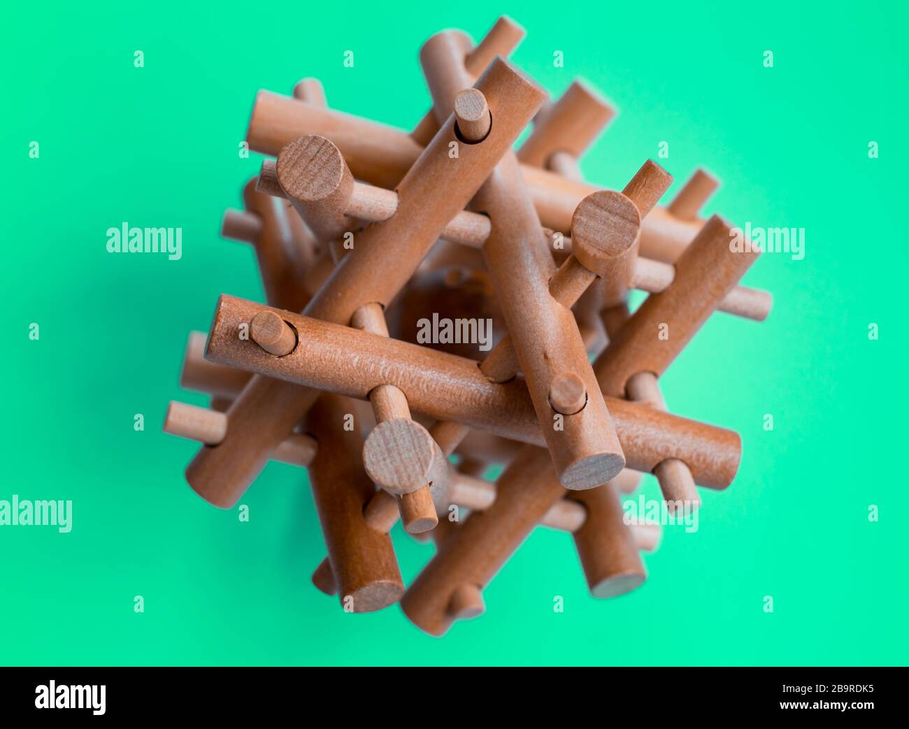 Wooden Brain Bamboo Puzzle on green background Stock Photo - Alamy