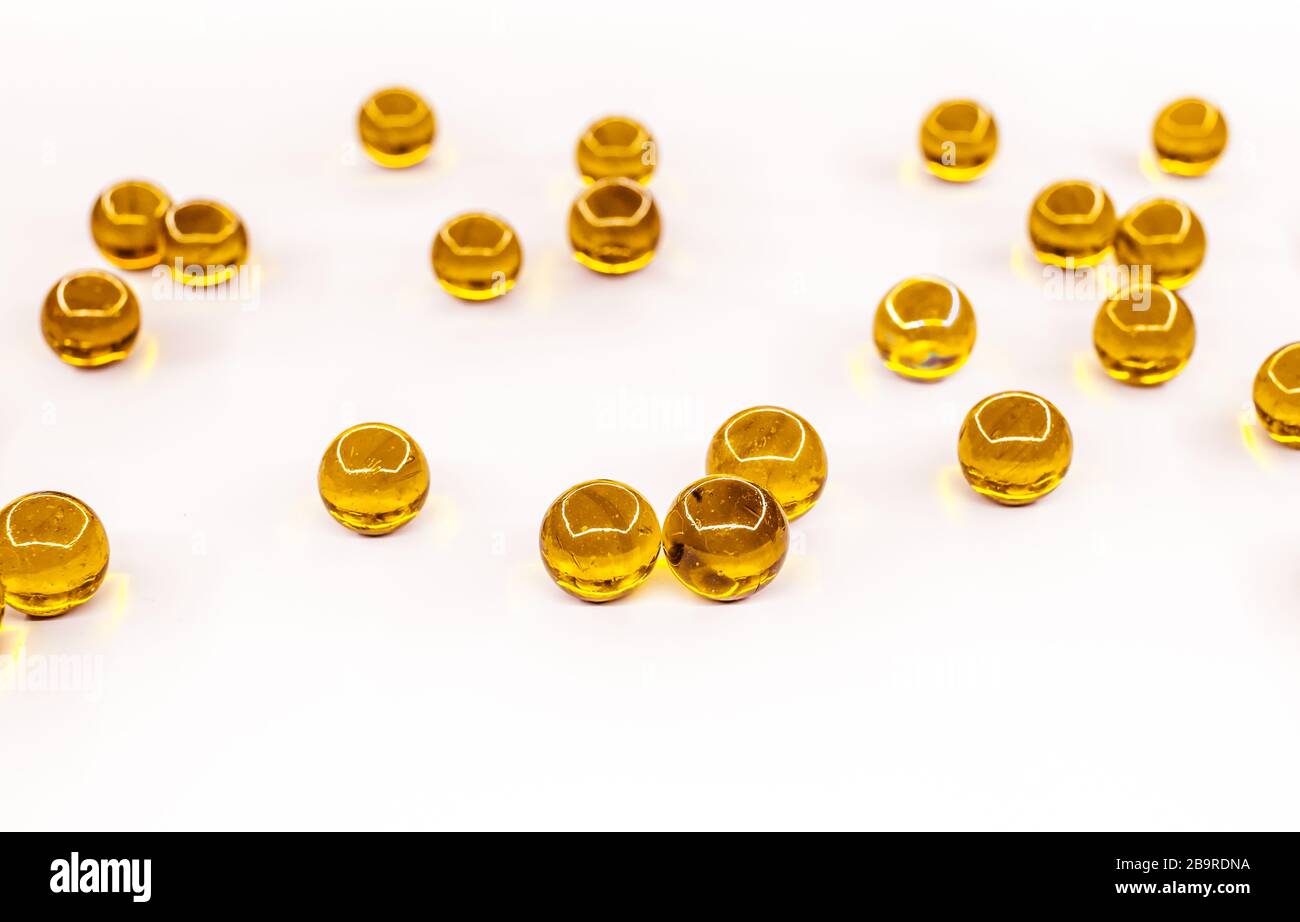 yellow glass balls on white background Stock Photo - Alamy