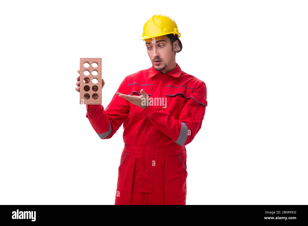 Young male builder showing brick hi-res stock photography and images ...