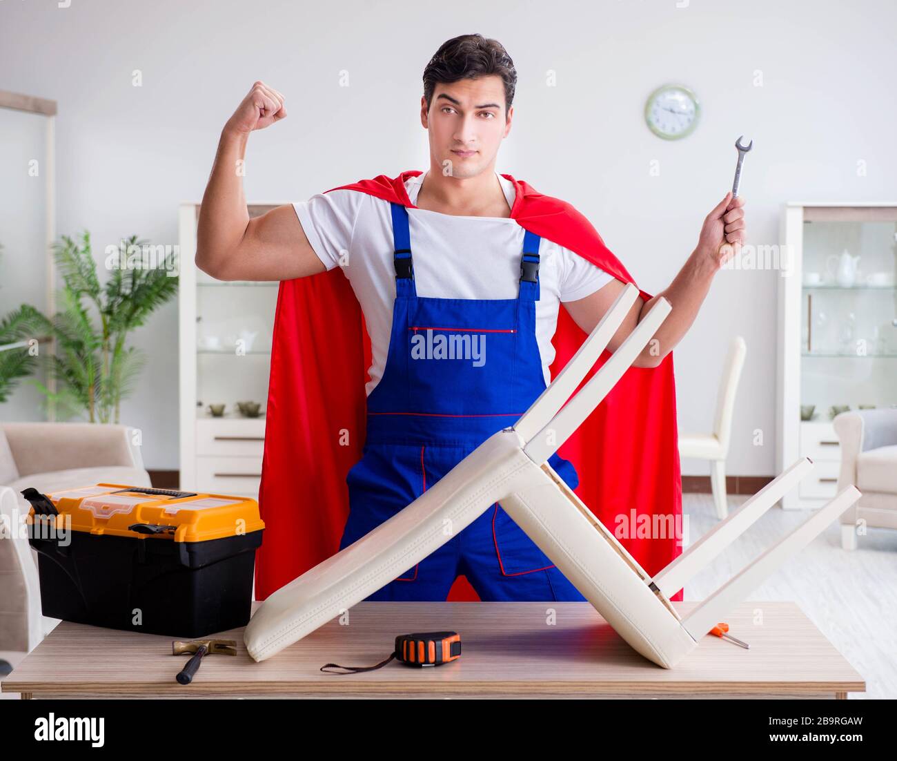 The superhero repairman with tools in repair concept Stock Photo - Alamy