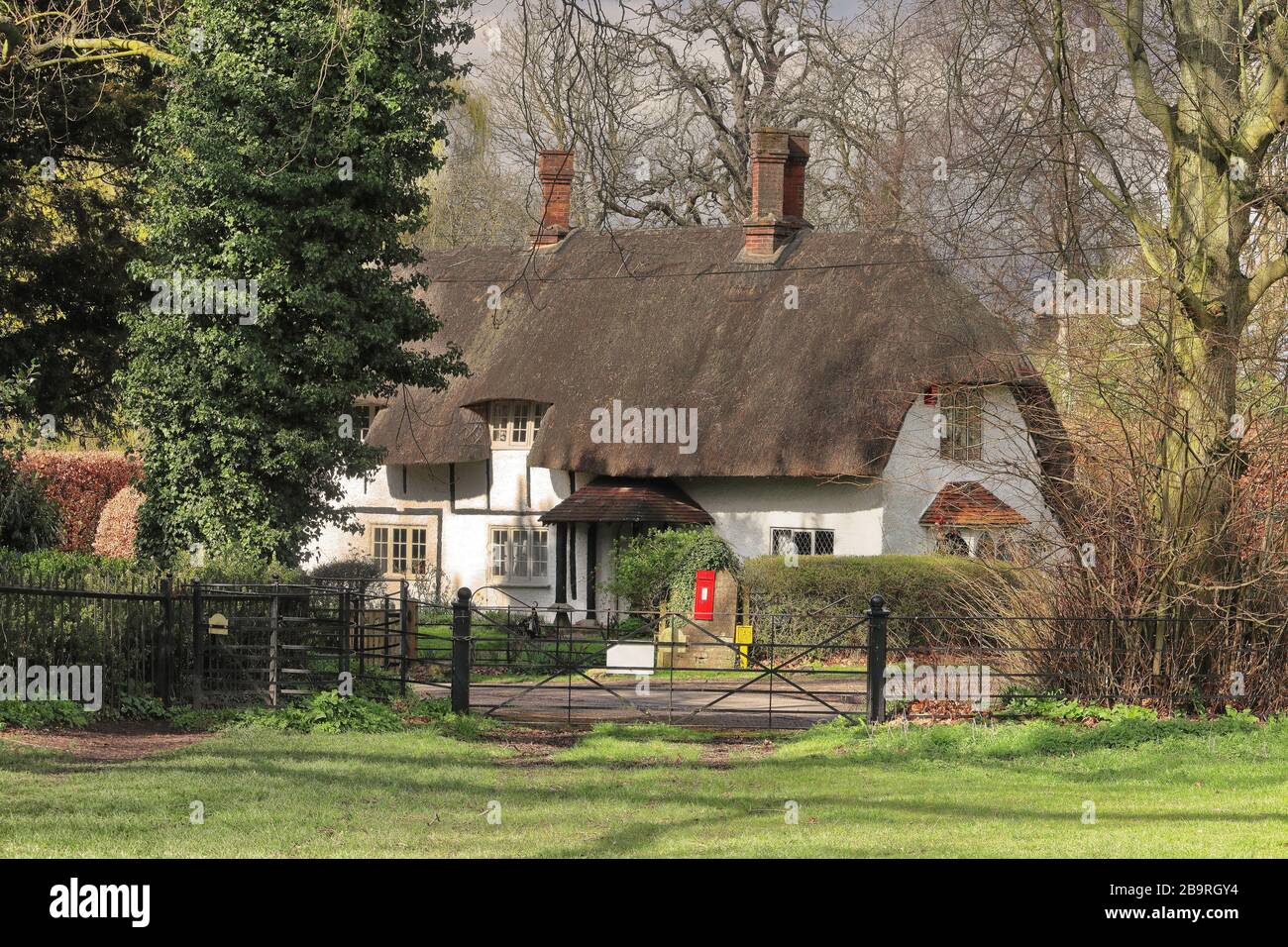 Traditional Thatched English Village Cottage with red postbox outside ...