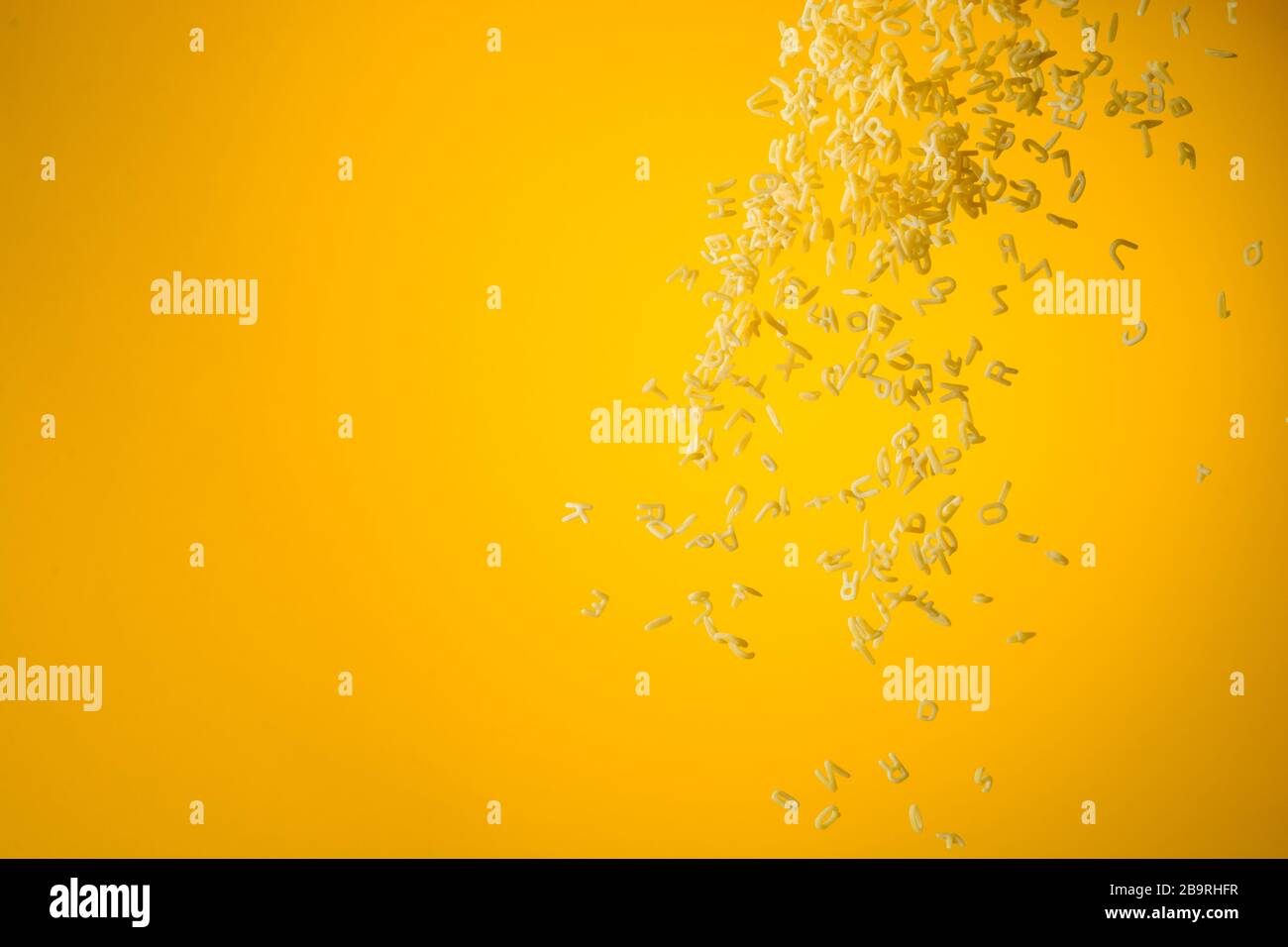 Zero gravity food concept. Flying uncooked pasta on yellow background ...