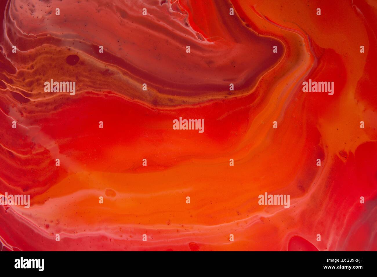 Volcanic red colors stains of liquid acrylic colors Stock Photo - Alamy