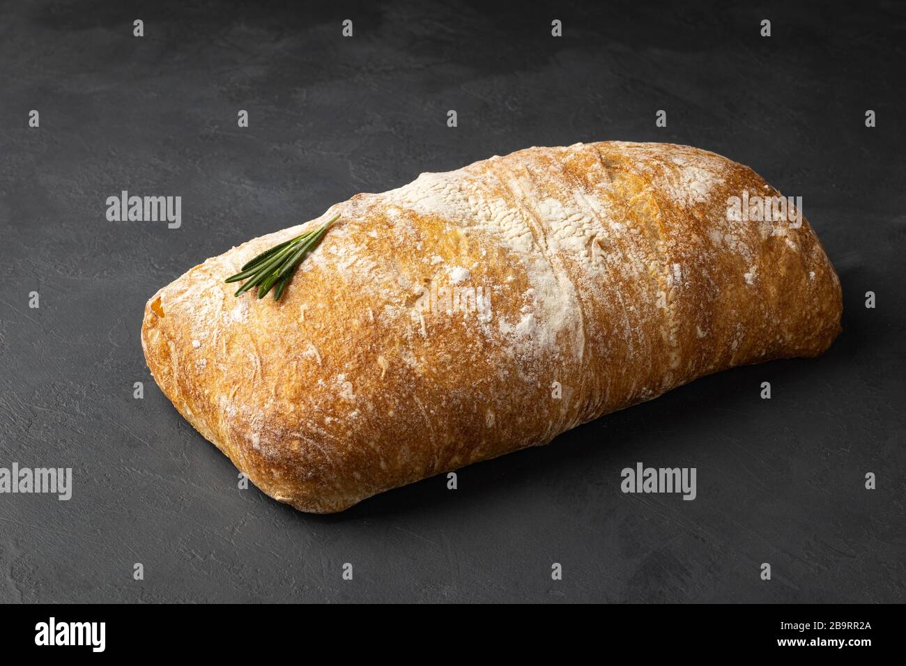 Crispy italian ciabatta bread on black background Stock Photo - Alamy