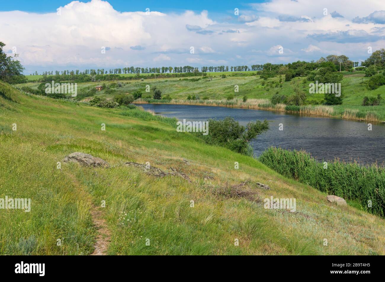 Ukrainian rural landscape with small river Sura at late spring season ...