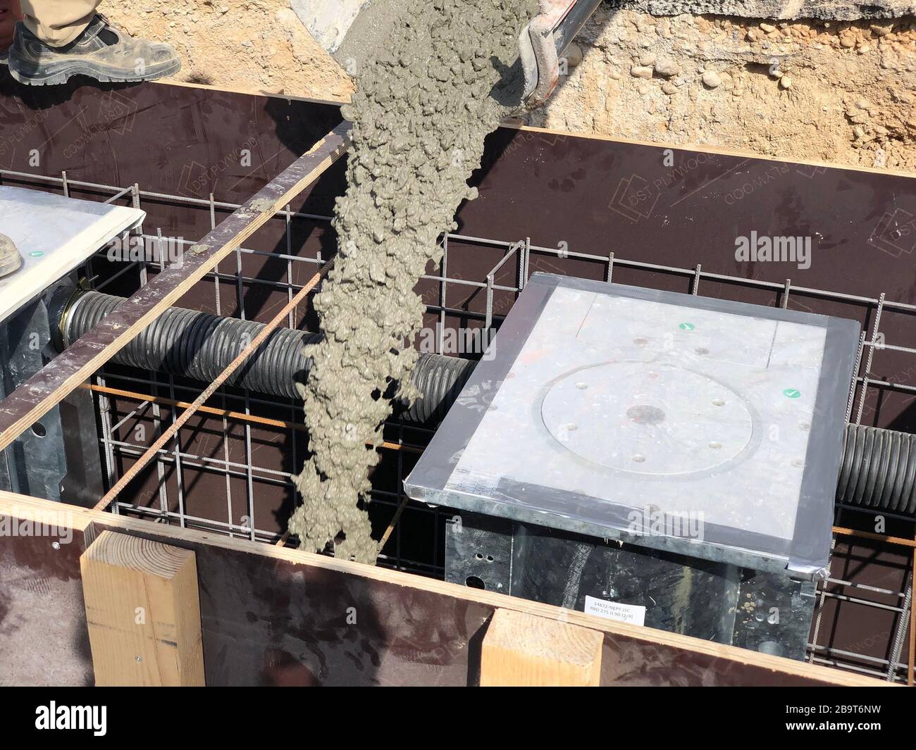 Pouring concrete to road bollard formwork foundation Stock Photo - Alamy