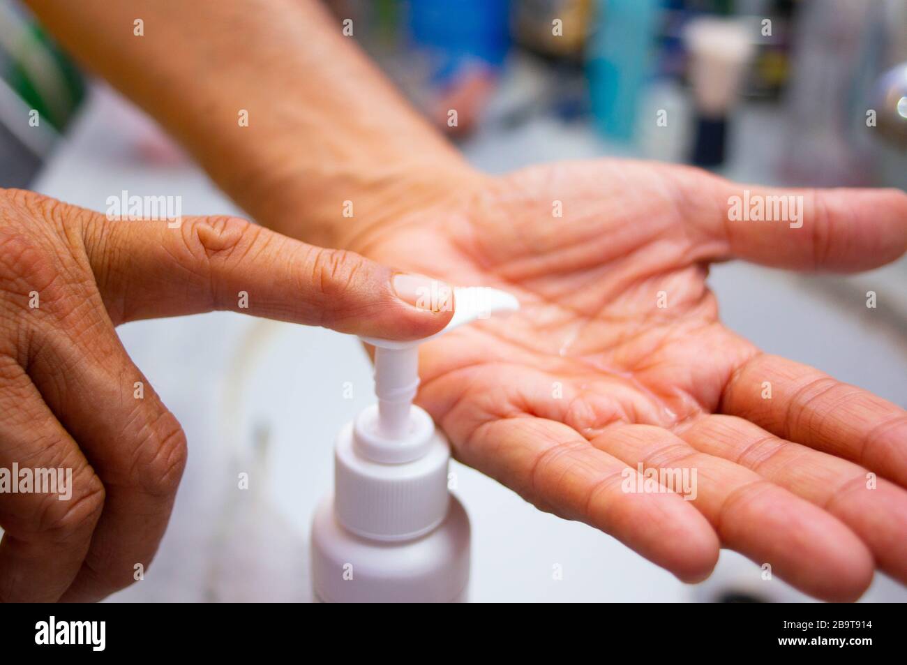 A person applying liquid soap or sanitizer on his hands Stock Photo - Alamy