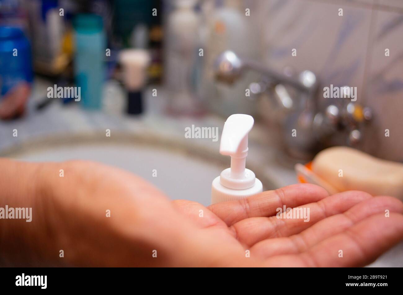 A person applying liquid soap or sanitizer on his hands Stock Photo - Alamy