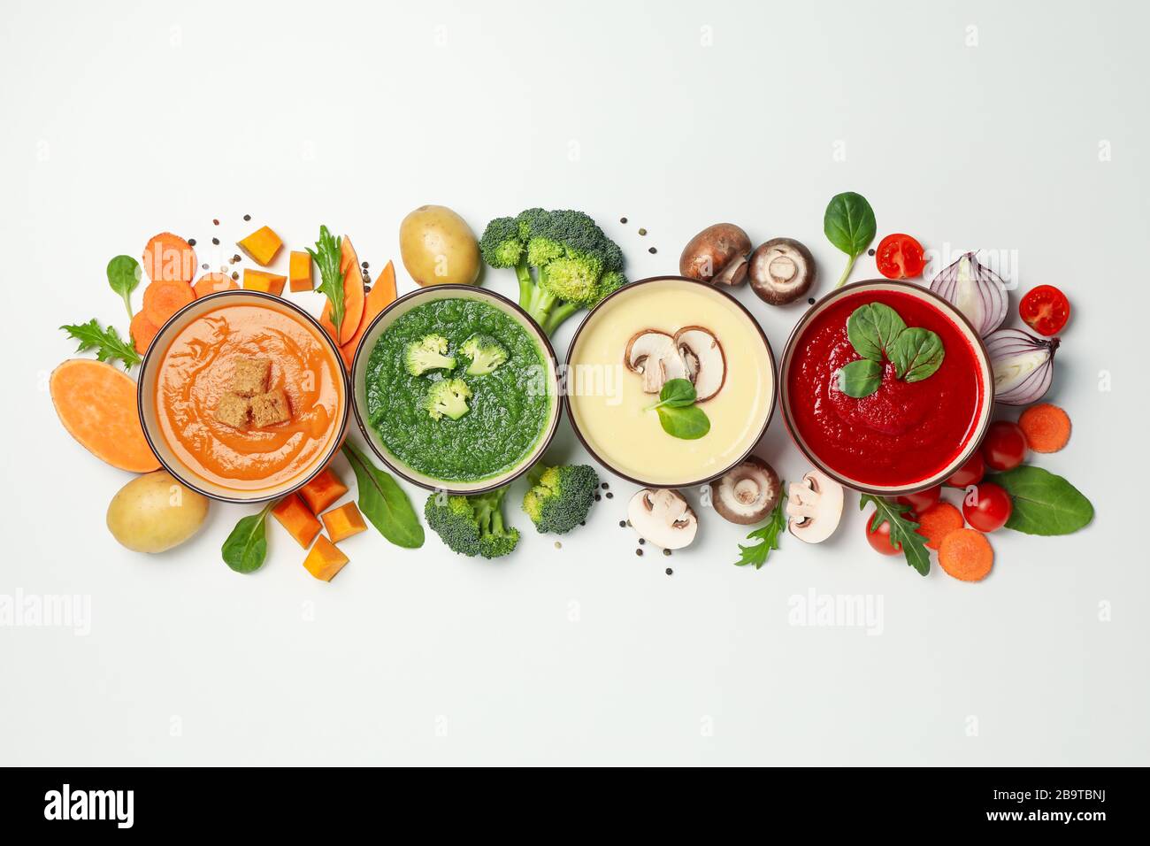 Vegetable soups and ingredients on white background, top view Stock ...