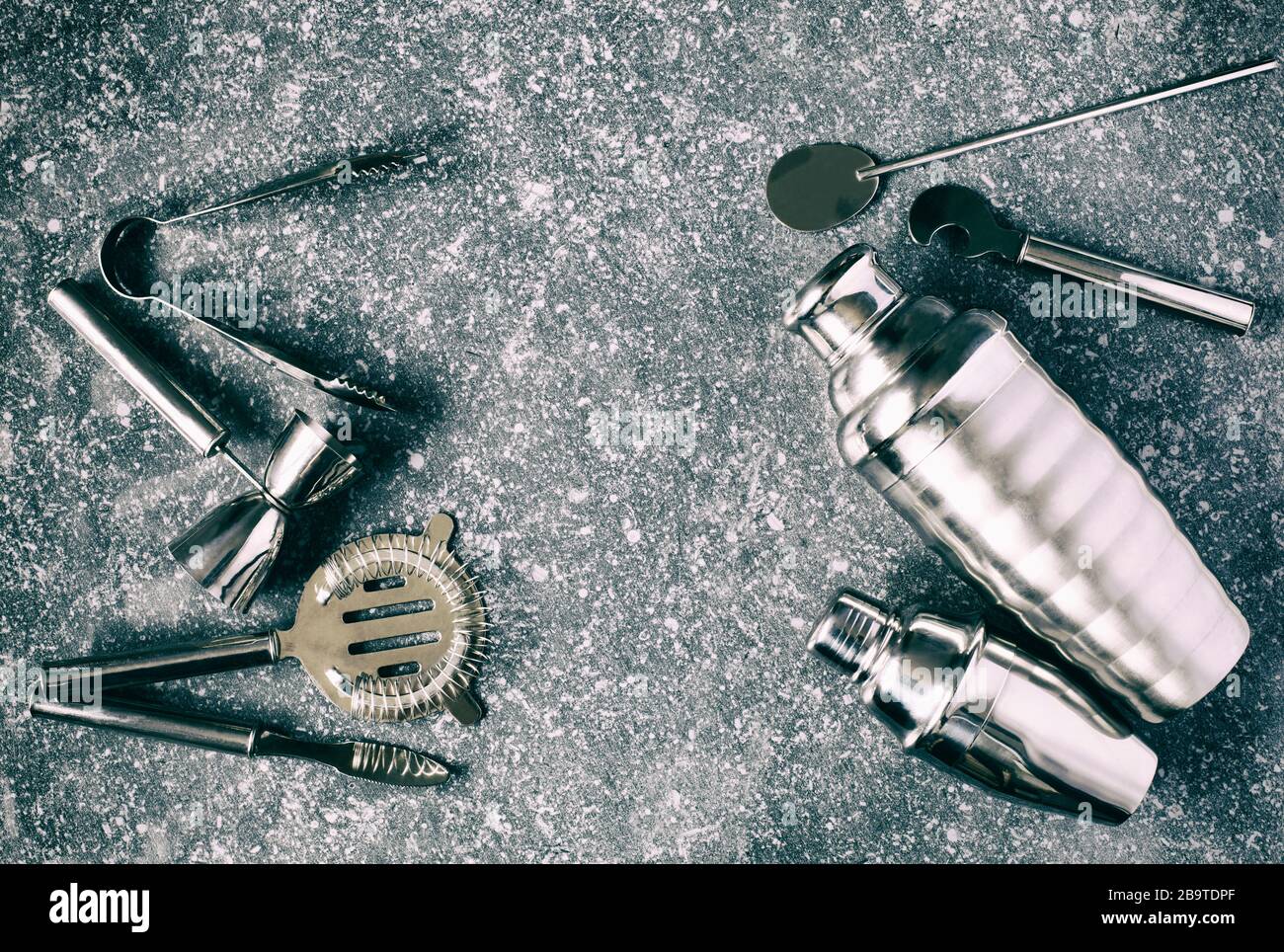 Set of bar tools for making a cocktails arranged on a stone background ...