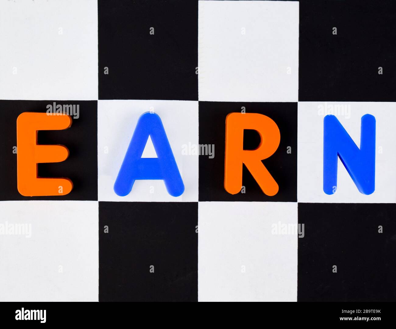 Earn word written with different colored letter blocks arranged on a ...