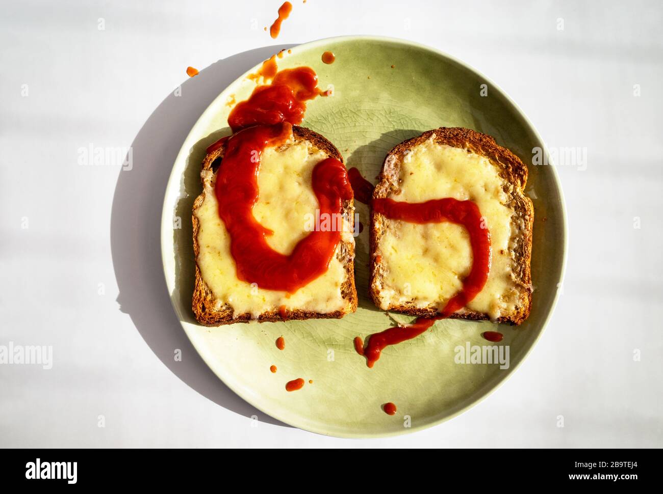 Cheese on toast with tomato ketchup Stock Photo - Alamy