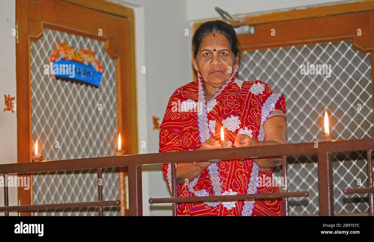 Indian woman decorates entrance hi-res stock photography and images - Alamy