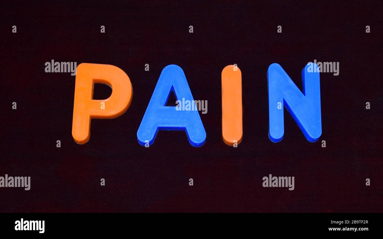 Pain word written with different colored letter blocks arranged on a ...