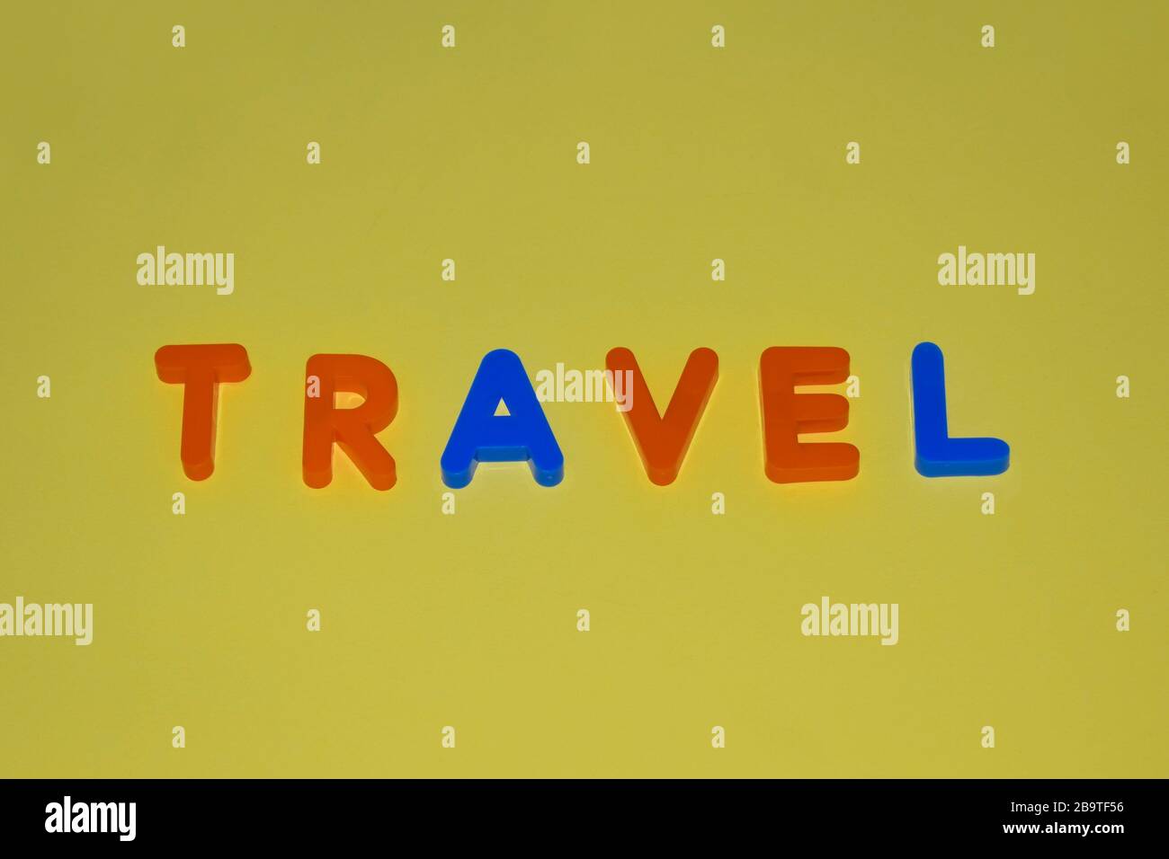 Travel word written with different colored letter blocks arranged on a ...
