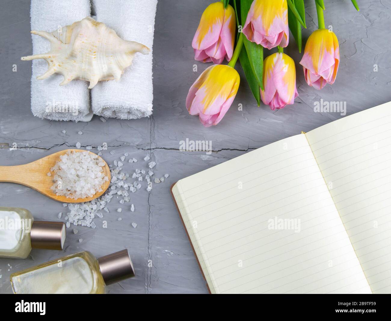 Spa with natural olive soap, tulips and sea salt and an open notebook ...