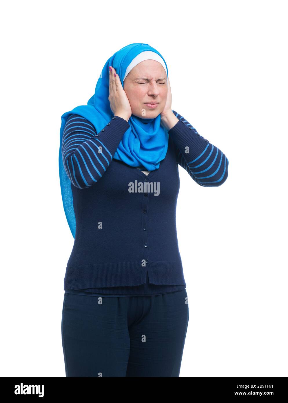 Angry Muslim woman covering ears with hands. Fear of loud sounds and ...