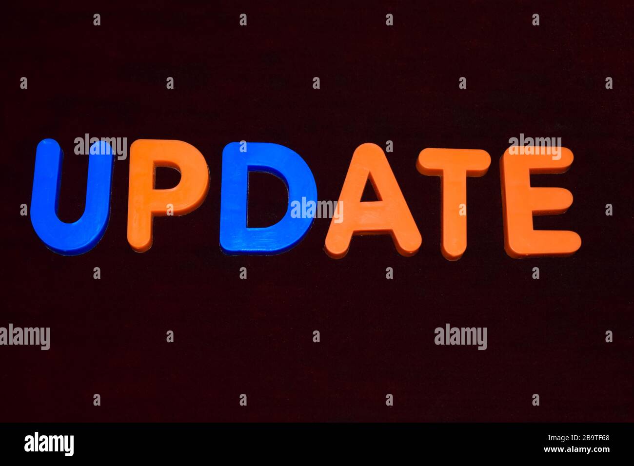 Update word written with different colored letter blocks arranged on a ...