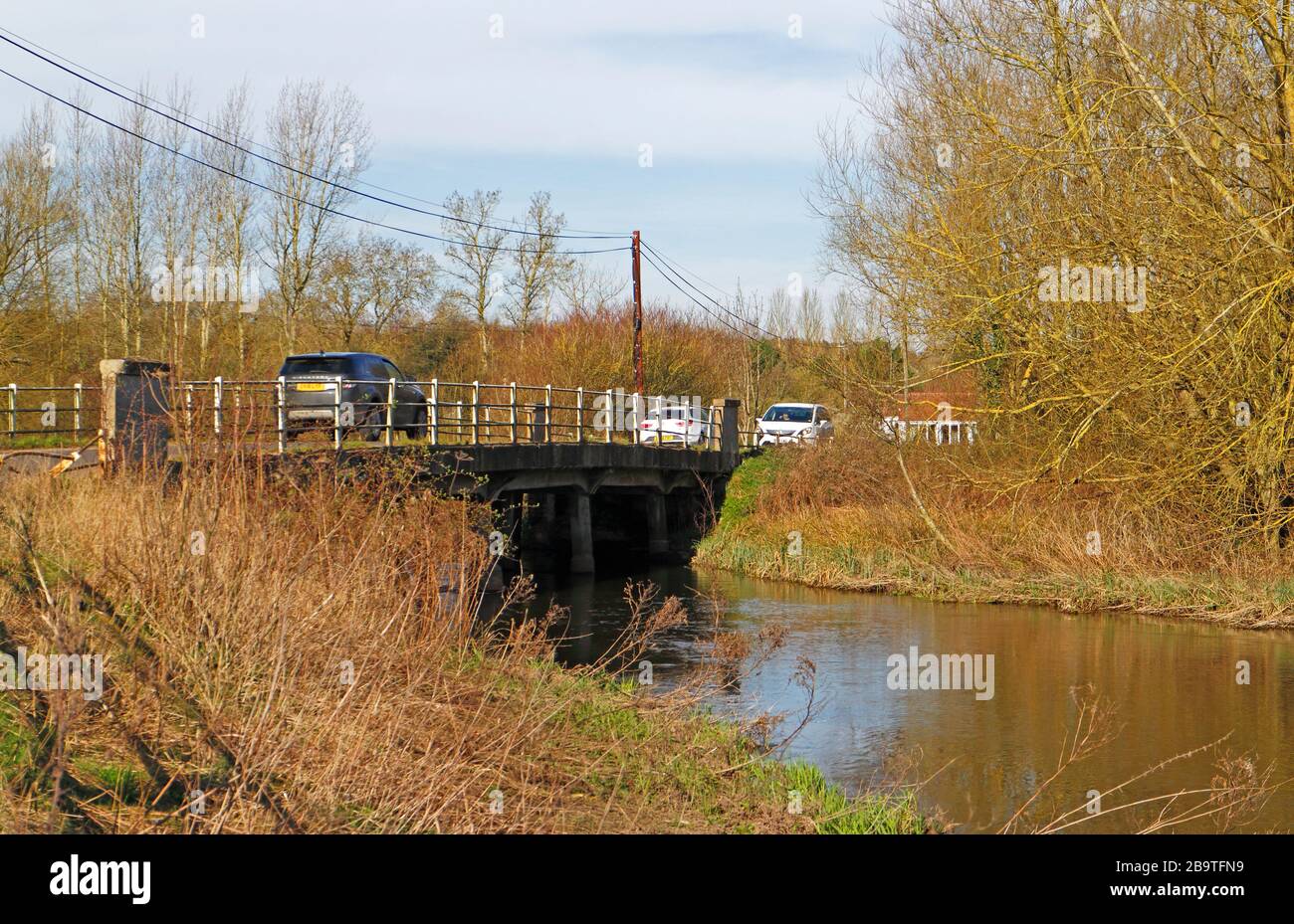 Traffic on a minor road bridge crossing the River Wensum in the English ...