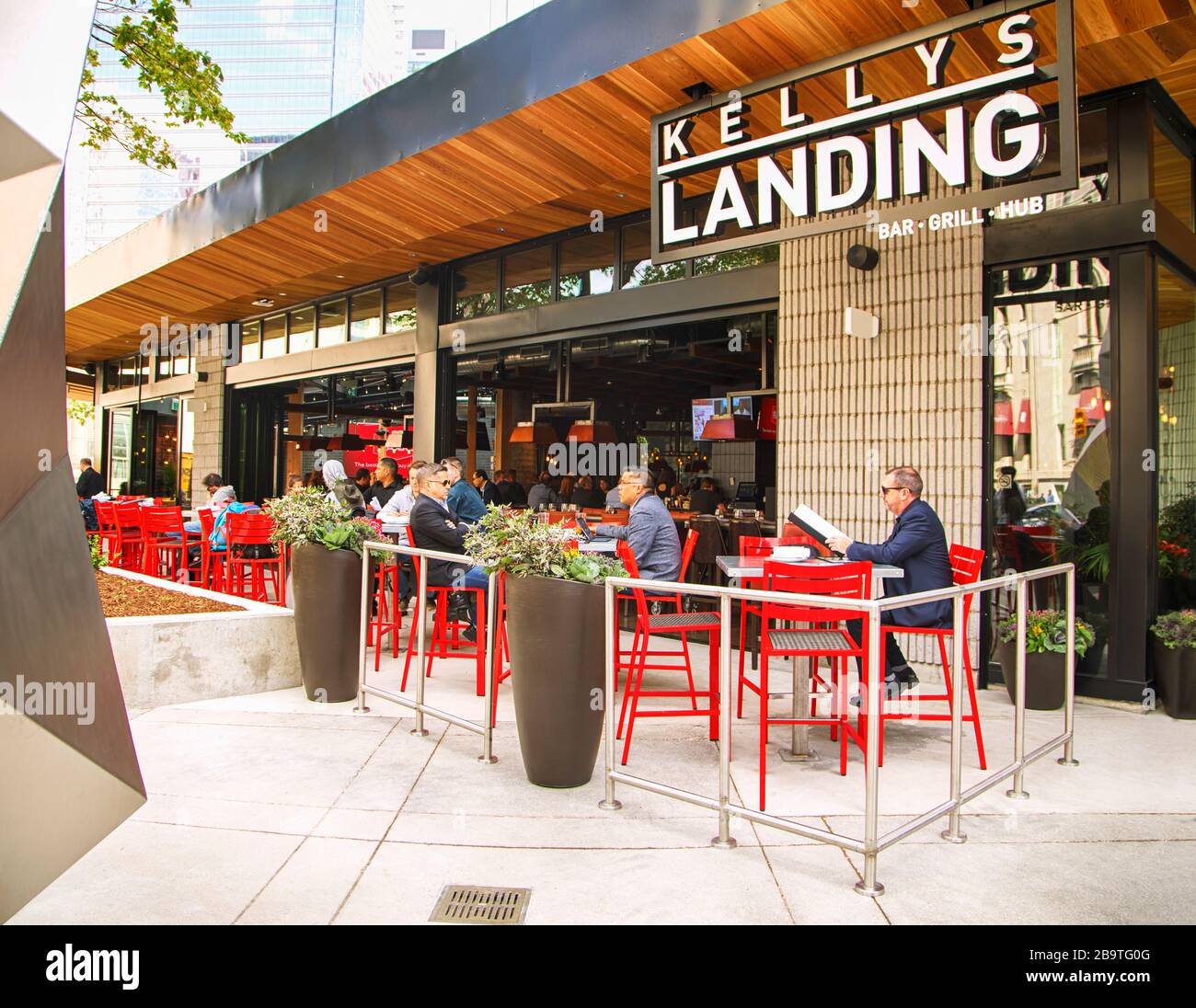 People eating and drinking in a street bar "Ellys Landing" in Toronto ...