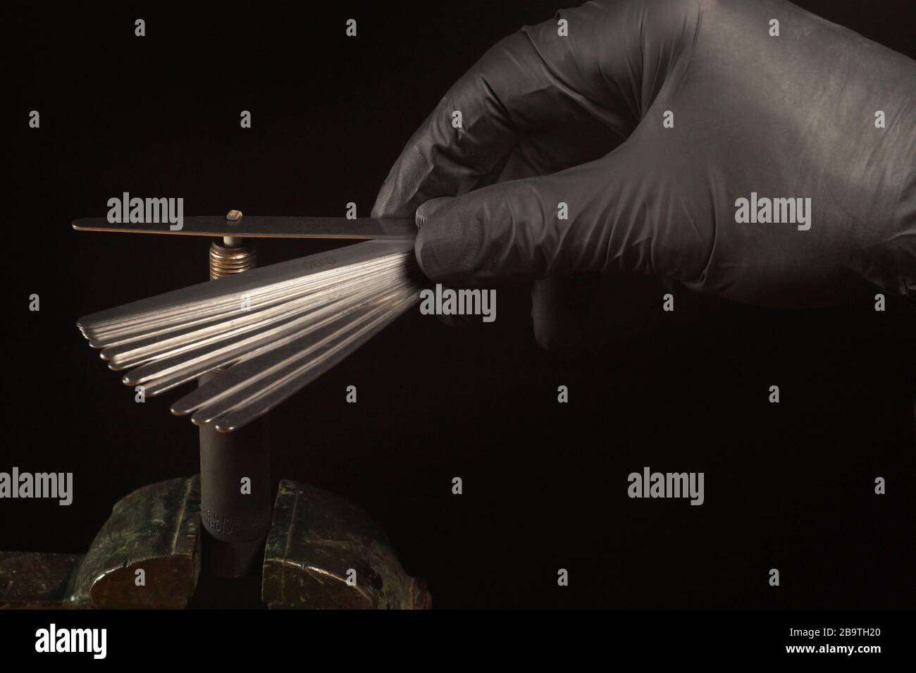 Internal combustion engine service. Measure the gap between the spark ...