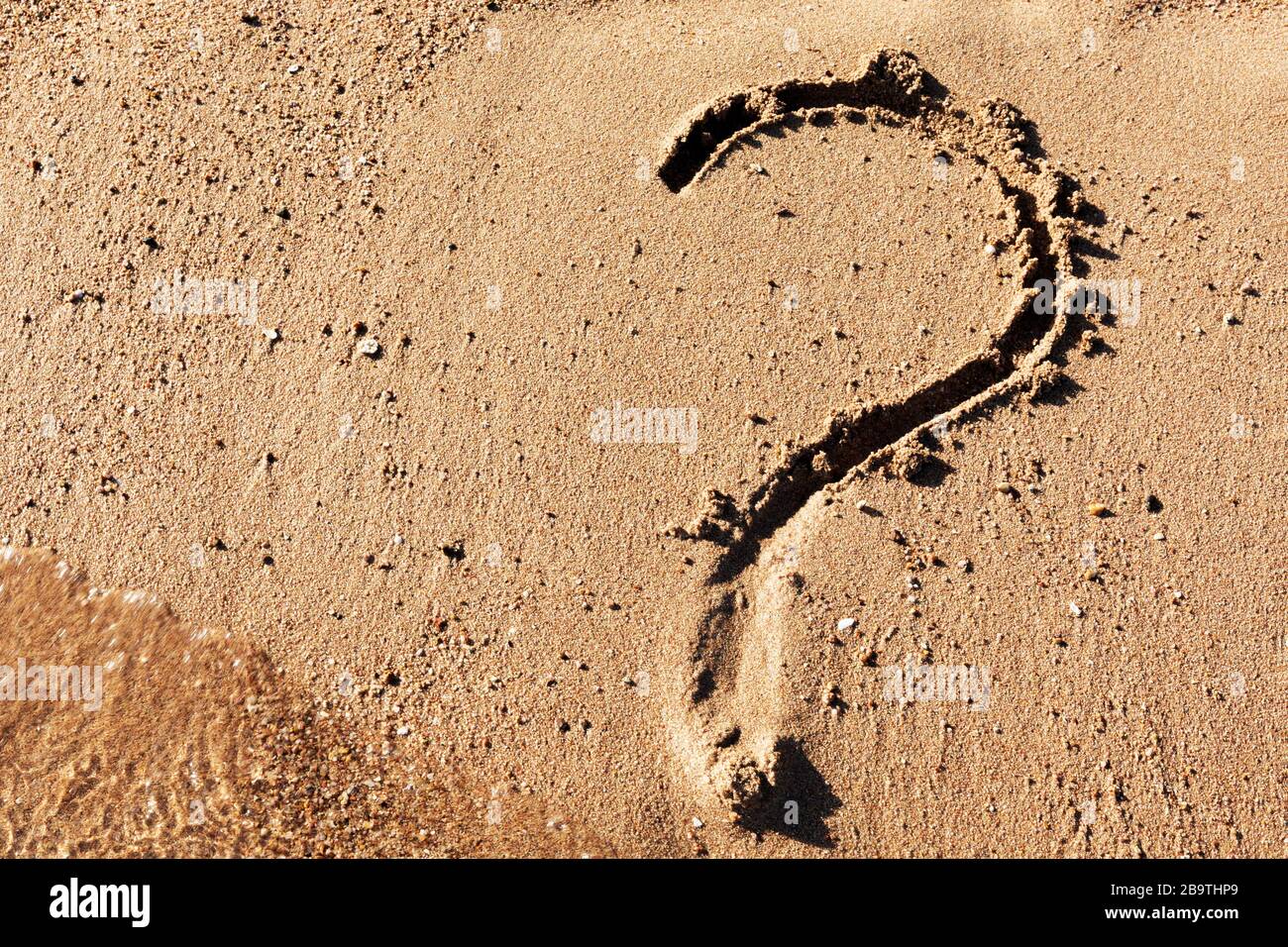 Question mark sign on sand beach near the sea. Concept of dilemma ...