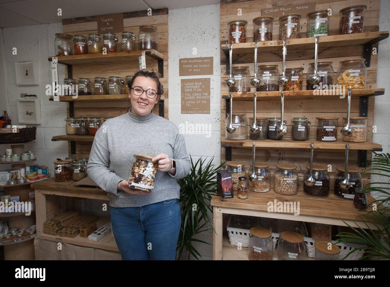 A shopkeeper in her zero waste store in the UK Stock Photo - Alamy