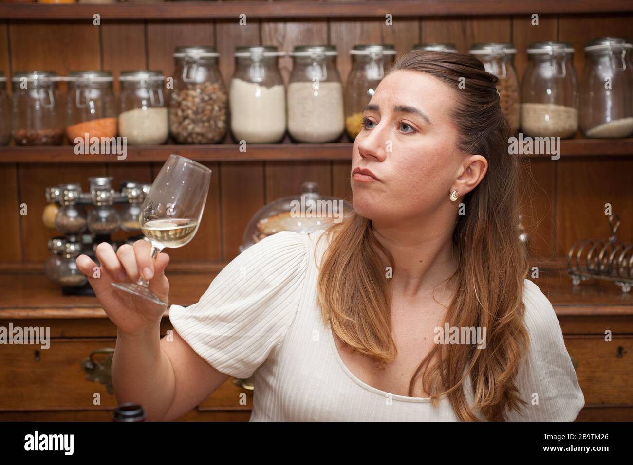 A female wine tester sampling a glass of wine wine Stock Photo - Alamy