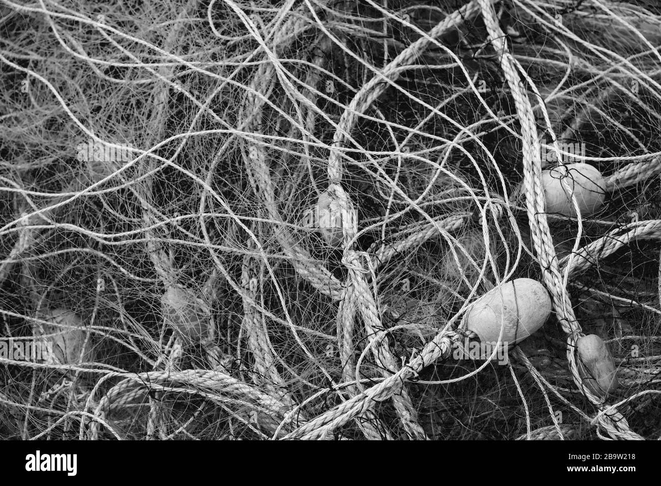 Drying fishing net with floats. Black and white background photo Stock ...