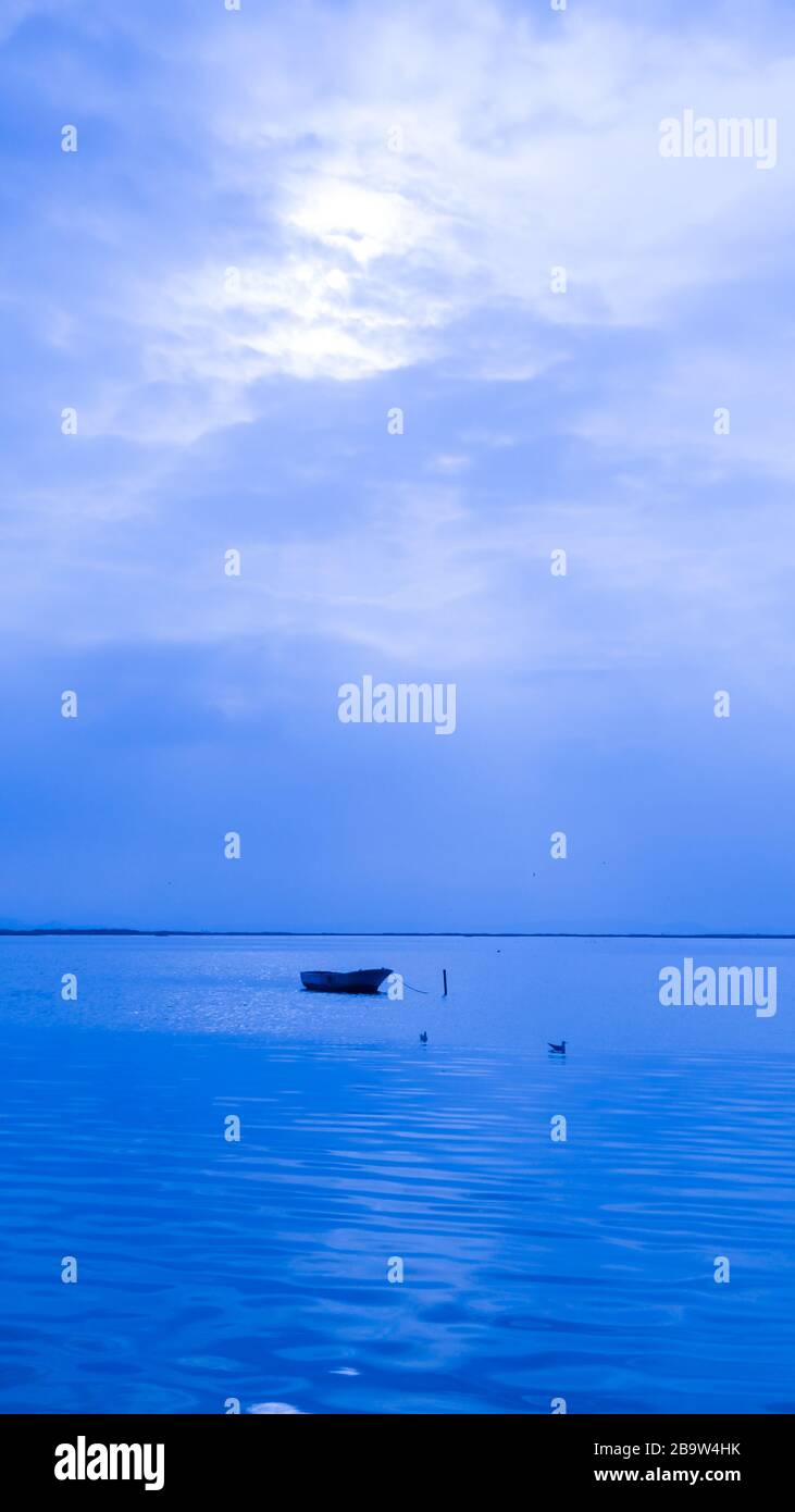 Small fishing boat floating on the sea water Stock Photo - Alamy