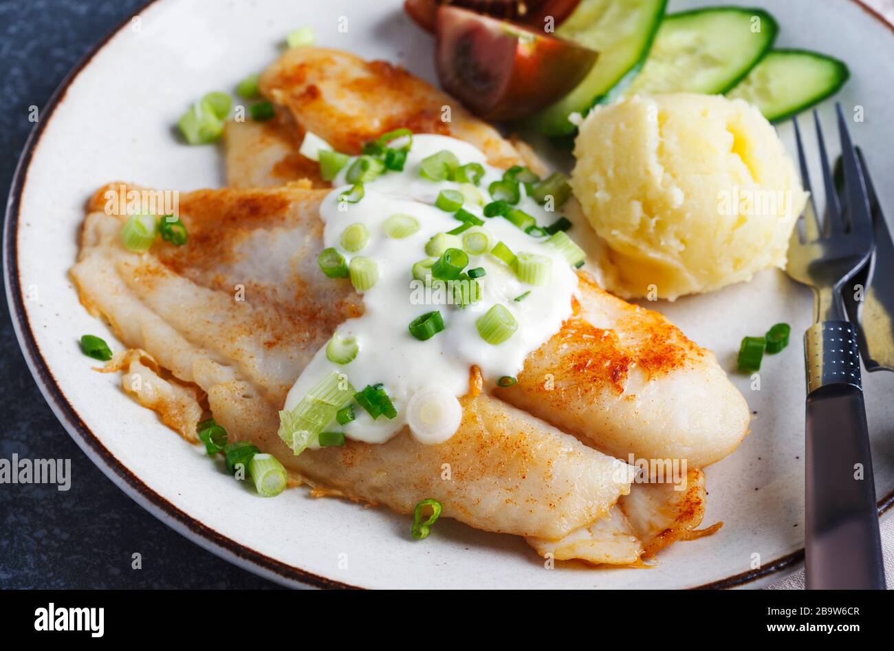 Fried Basa Fillet with sauce, mashed potato and fresh vegetables Stock ...